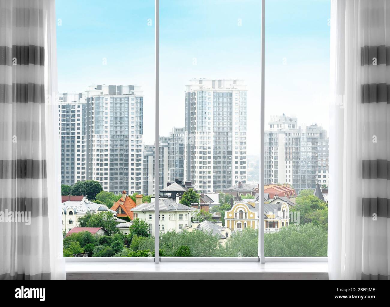 Cityscape view through modern window in room Stock Photo - Alamy