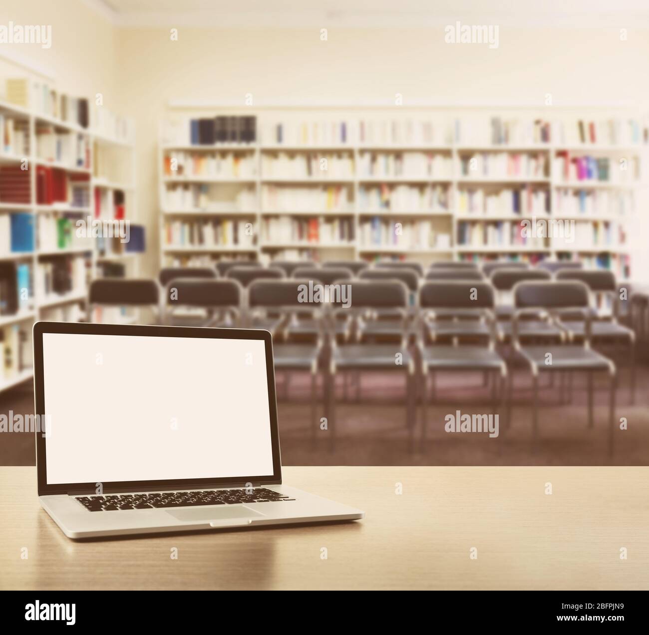 Modern laptop with blank screen on table in school library Stock Photo ...
