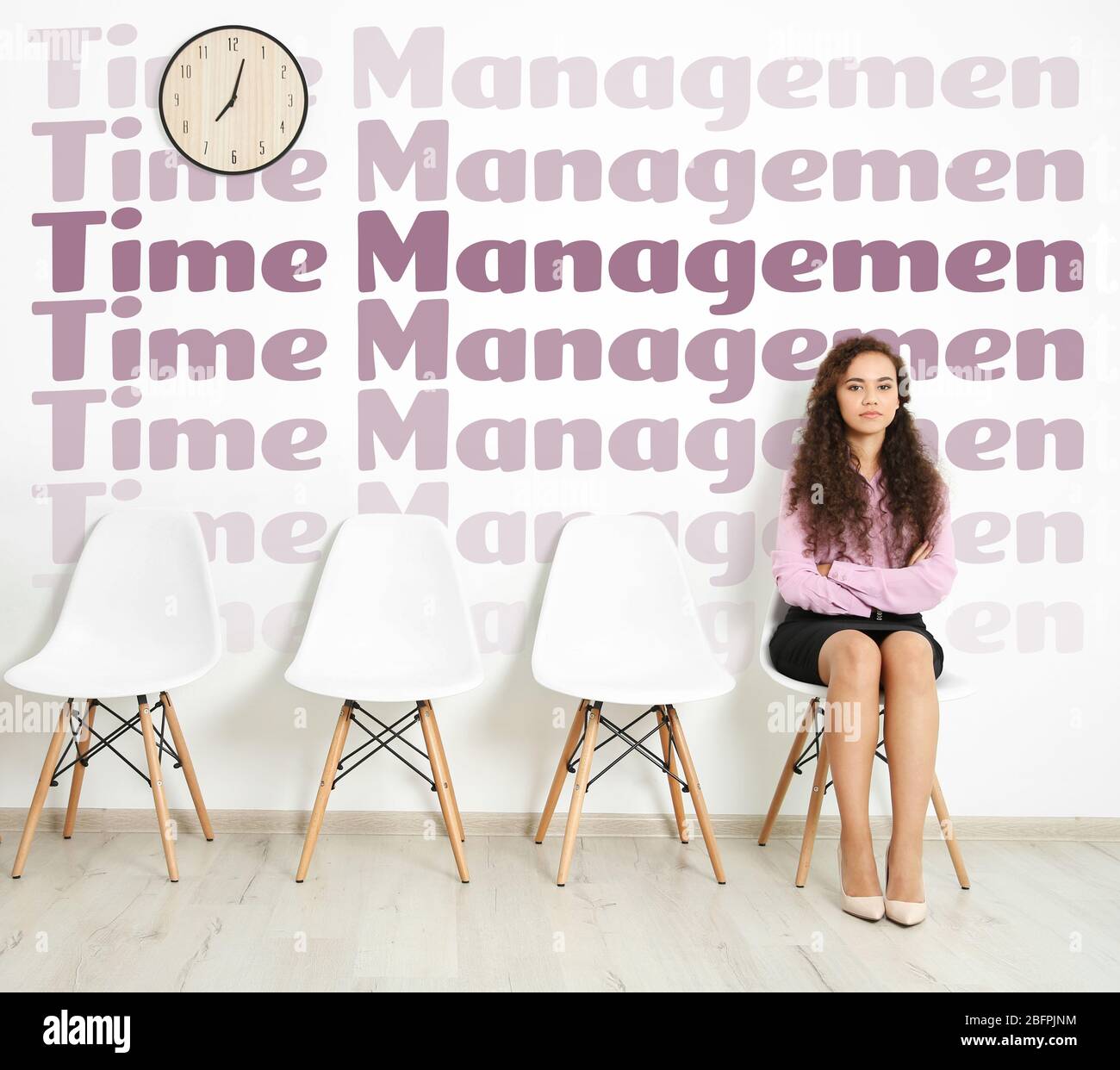 Time management concept. Young woman sitting on chair in office Stock ...