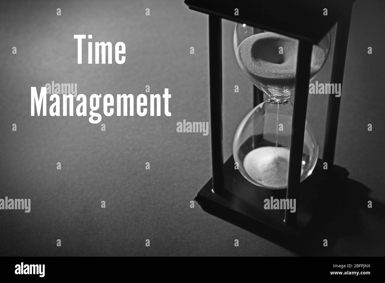 Time management concept. Hourglass on gray background Stock Photo - Alamy