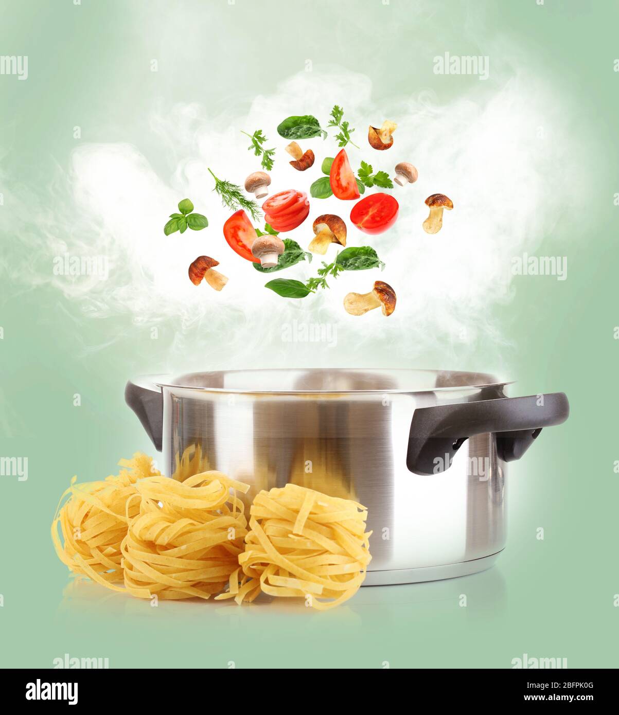 Ingredients falling into saucepan on color background. Tasty pasta ...