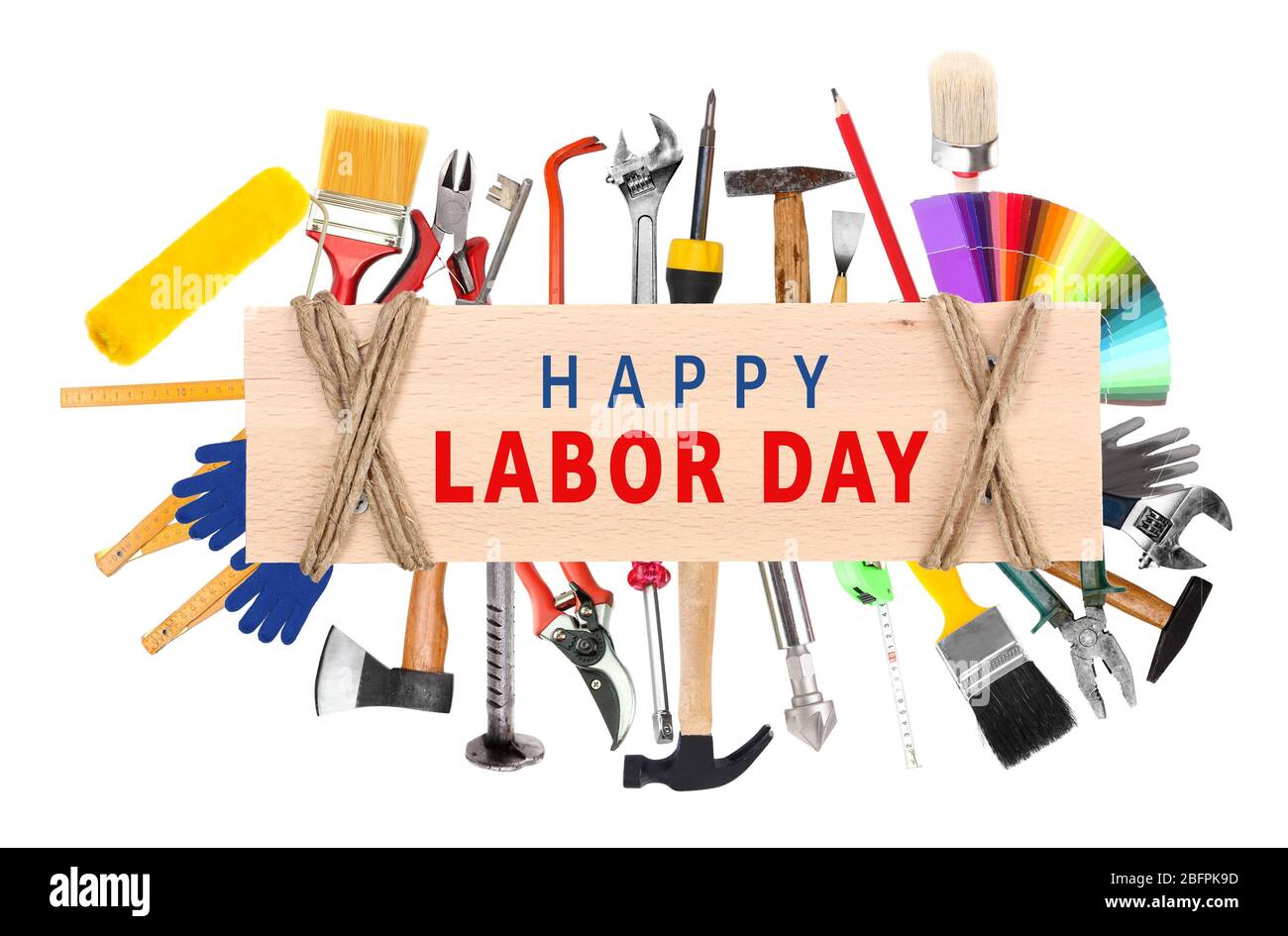 Wooden board with text HAPPY LABOUR DAY and different tools on white ...