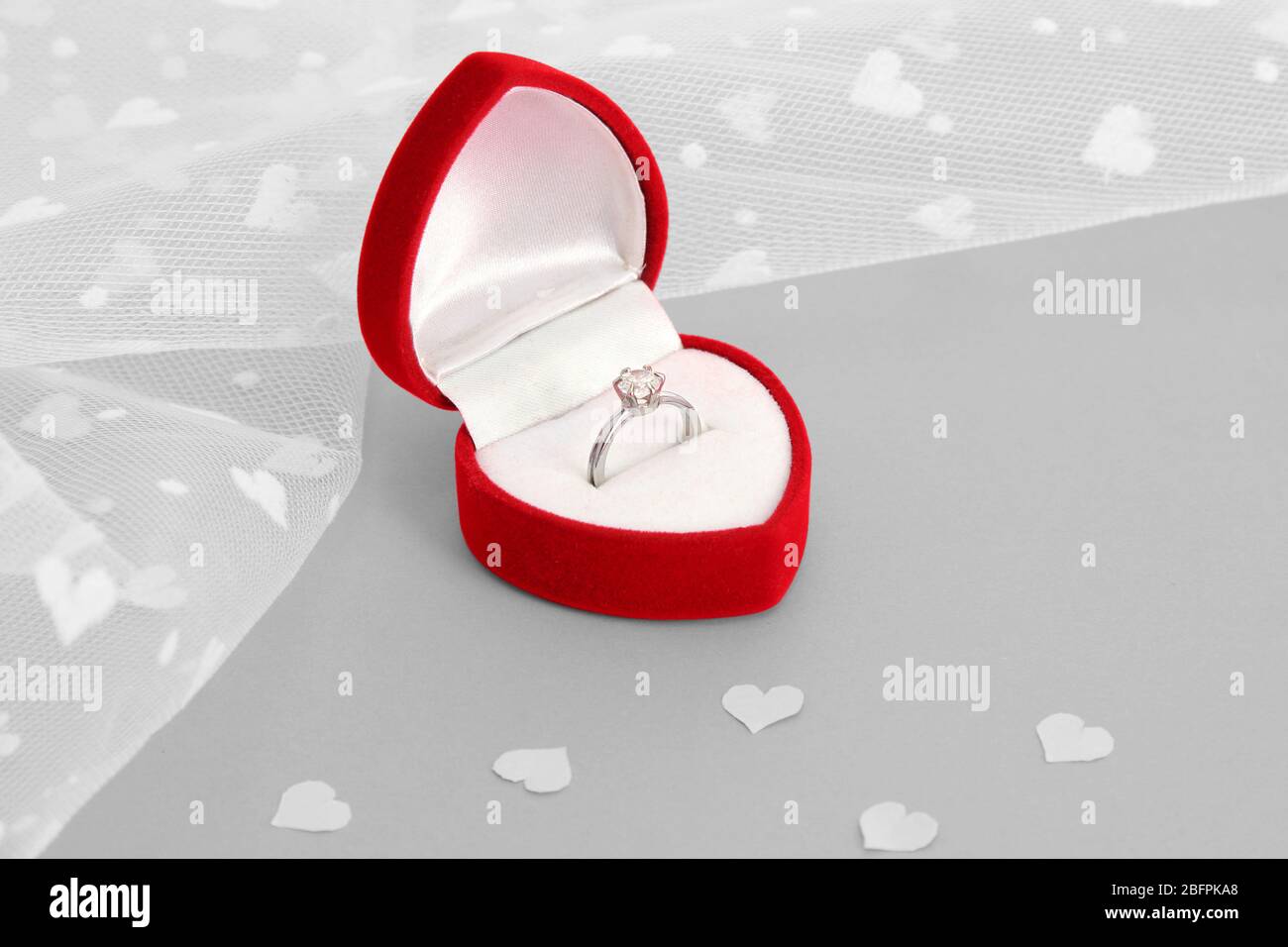 Red box with ring for marriage proposal on gray background Stock Photo ...