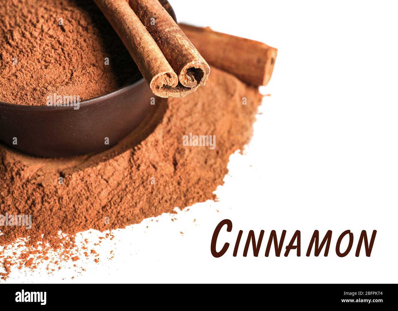 Cinnamon stick and powder with bowl on white background Stock Photo - Alamy