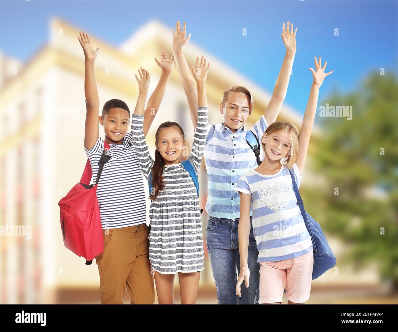 Children waving classroom hi-res stock photography and images - Alamy