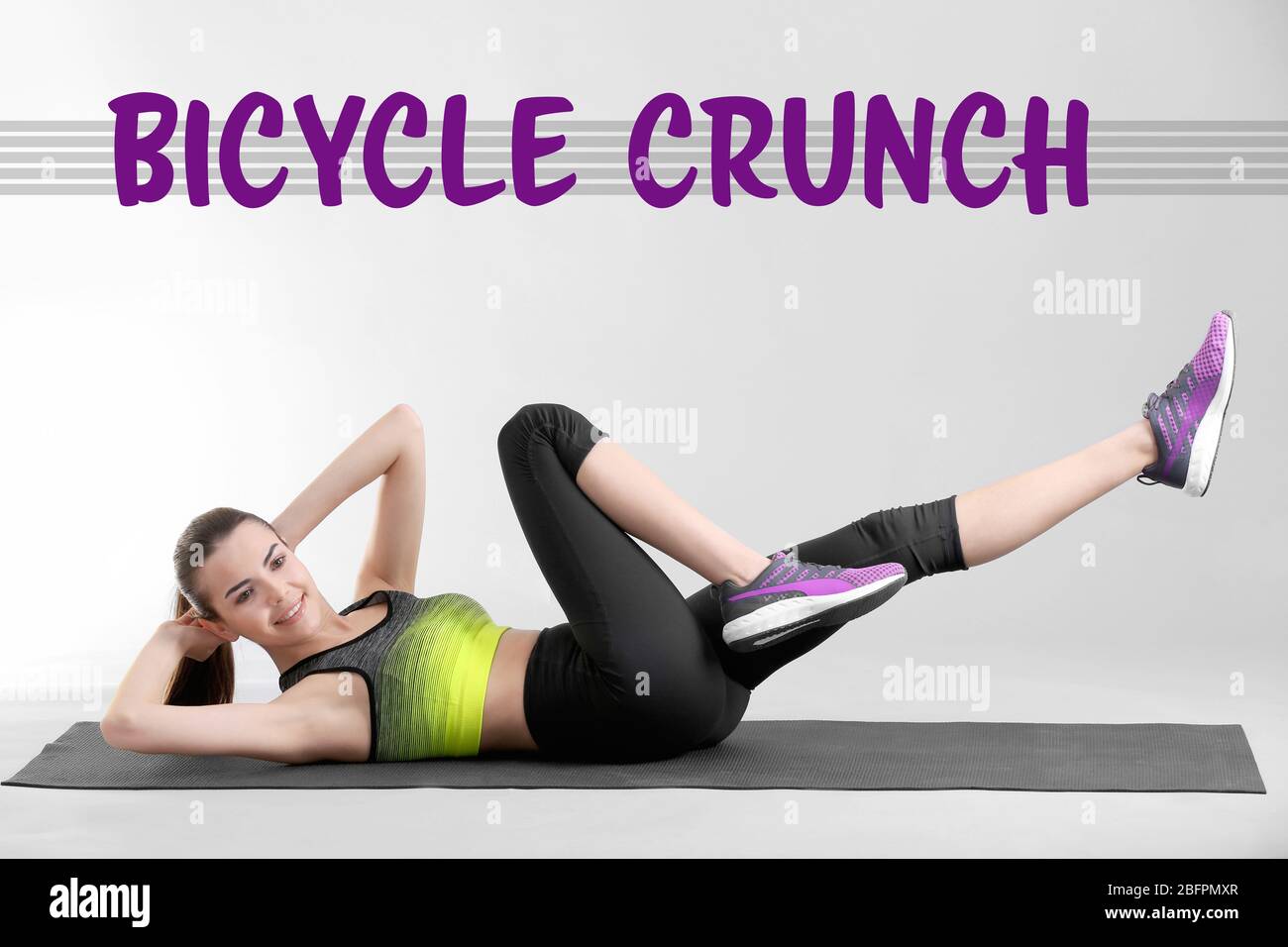 Young woman doing bicycle crunch on light background Stock Photo - Alamy