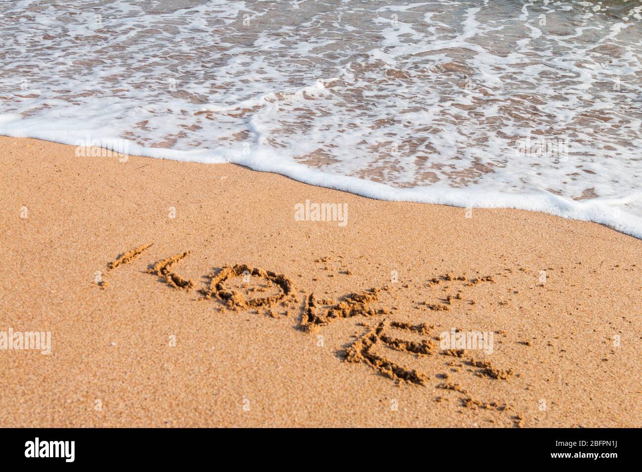 Romantic love lettering and heart sign on the beach beach Stock Photo ...