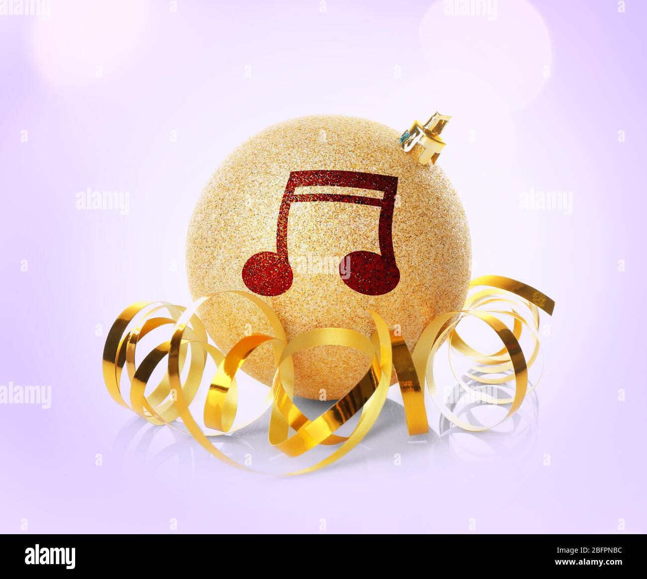 Ball with note and streamer on color background. Concept of Christmas ...