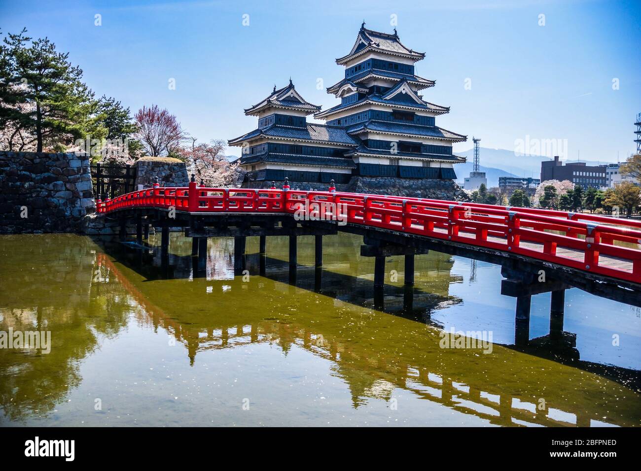 Japanese castle and red bridge in Matsumoto Stock Photo - Alamy