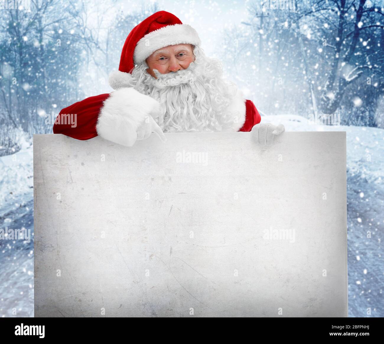 Santa Claus with blank poster on blurred background Stock Photo - Alamy