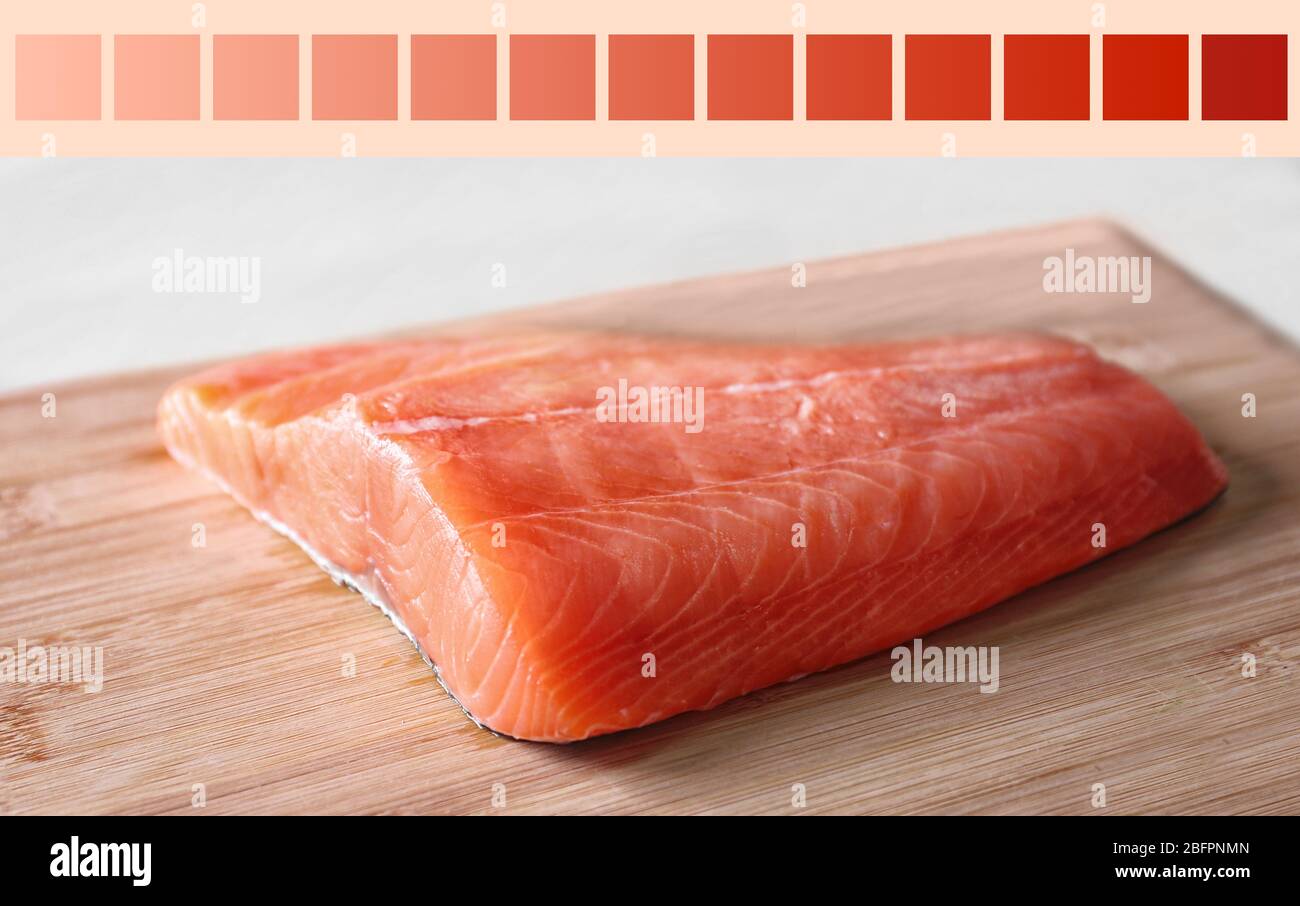 Salmon color lineal and fish fillet on wooden board Stock Photo - Alamy