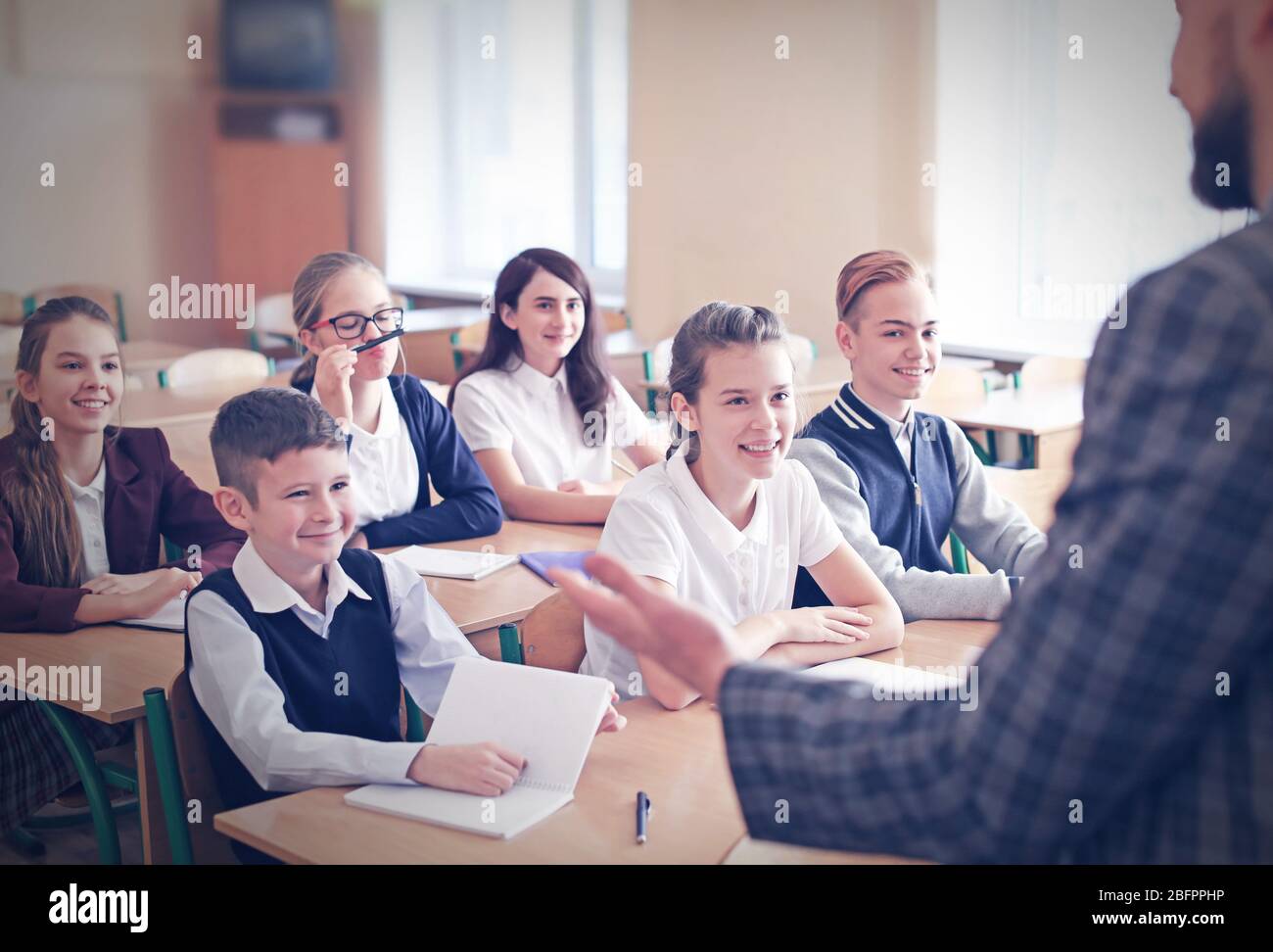 Children listening teacher in classroom at school Stock Photo - Alamy