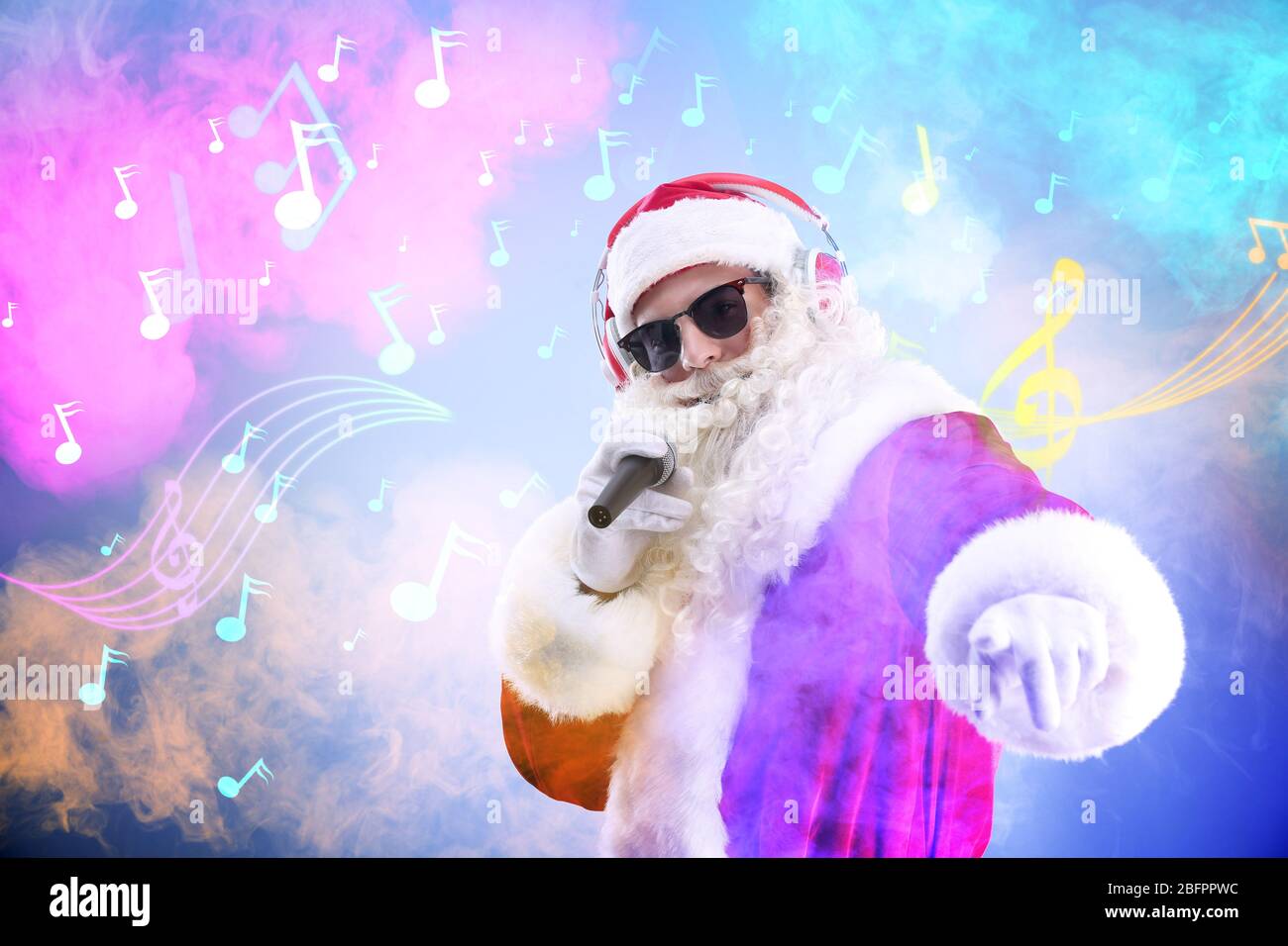 Santa Claus singing songs on blurred lights background. Christmas and ...