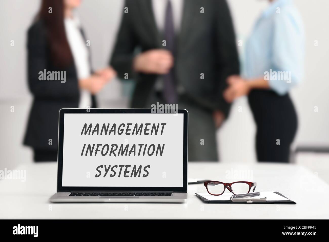 Concept of management information systems. Workplace with laptop and ...