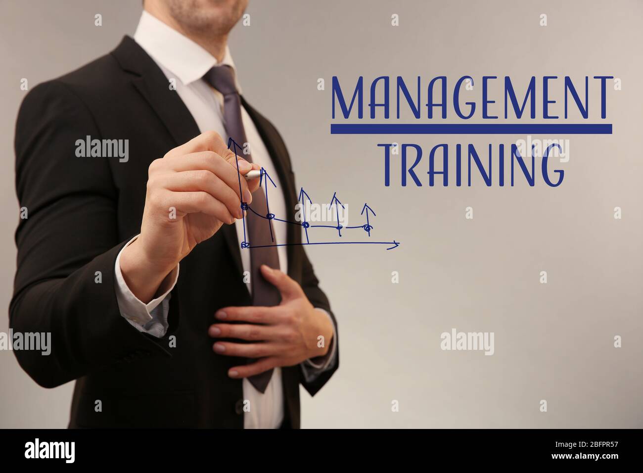 Concept of management training. Young man drawing diagram on virtual ...