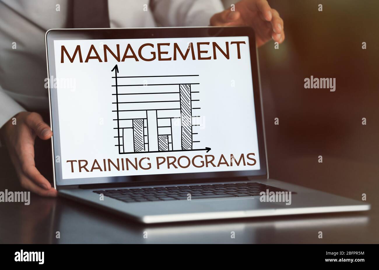 Concept of management training programs. Businessman showing diagram on ...