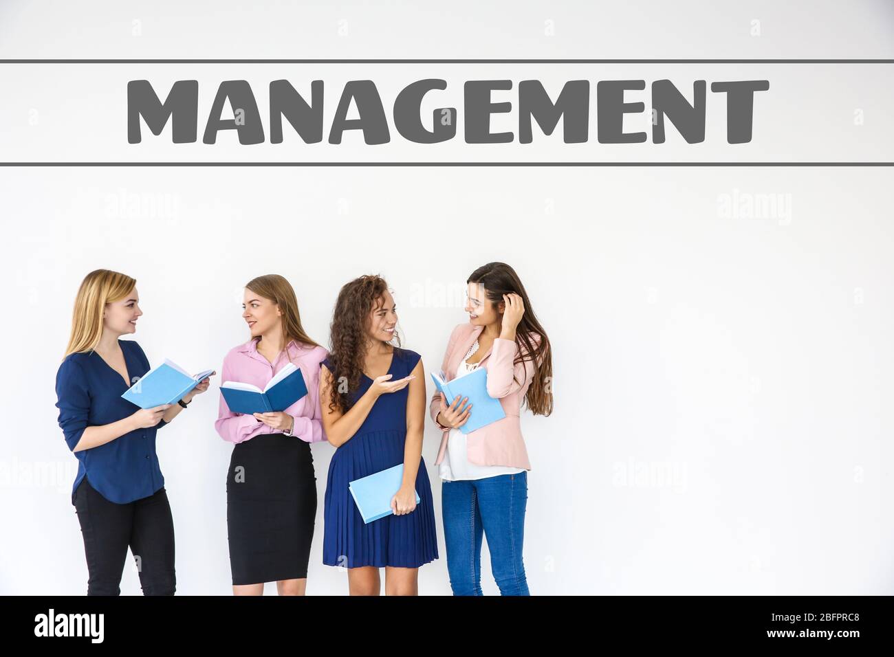Management concept. Young managers with books on white background Stock ...