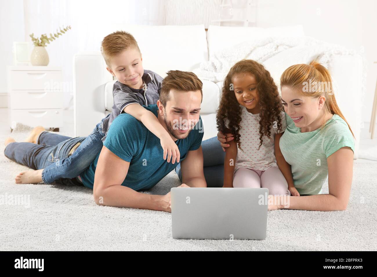 Family using laptop for browsing internet store at home. Online ...