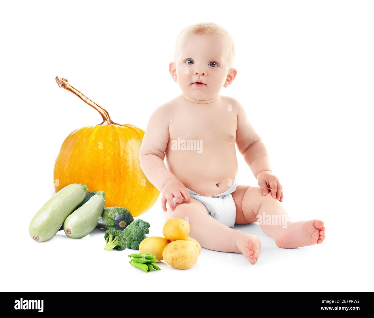 Cute baby with vegetables on white background. Healthy food concept ...