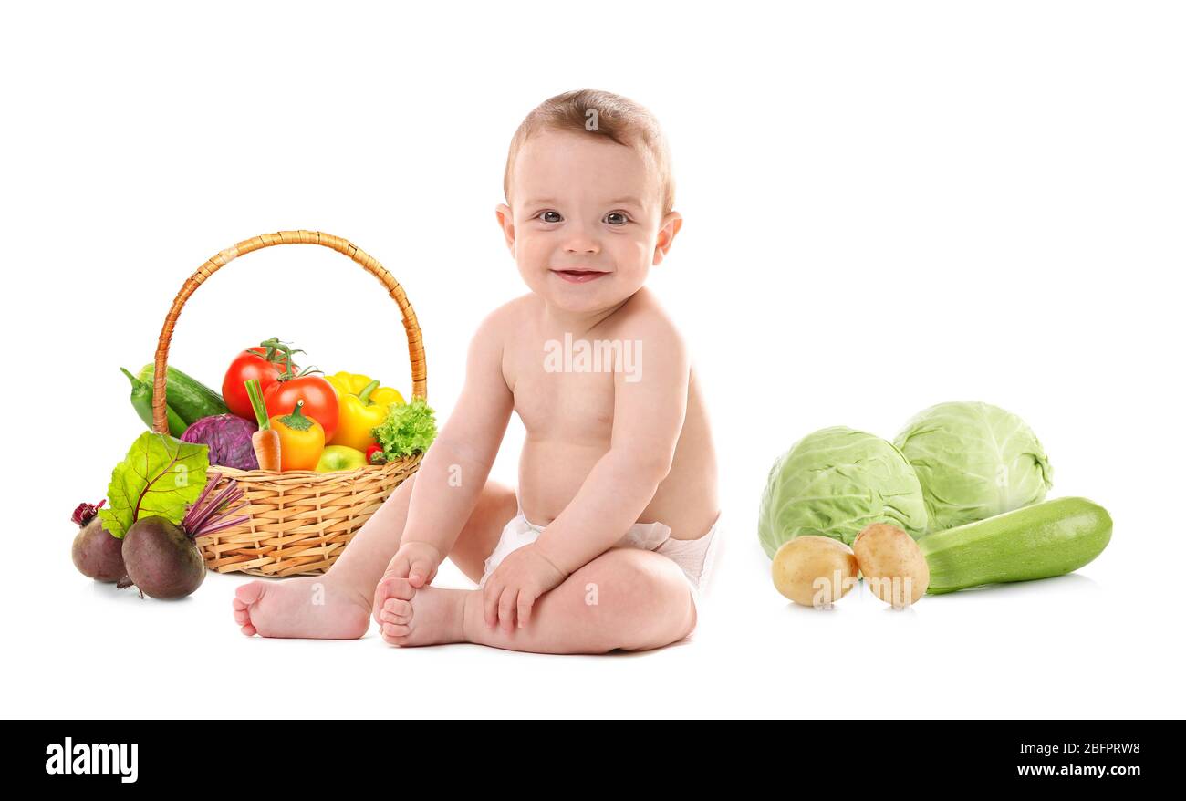 Cute baby with vegetables on white background. Healthy food concept ...