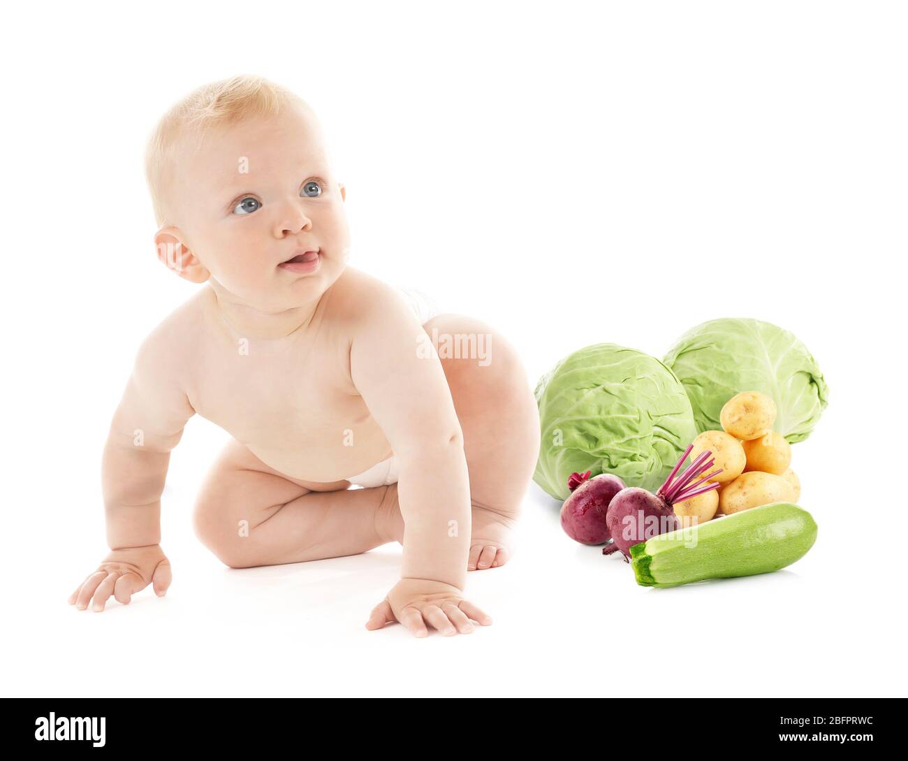 Cute baby with vegetables on white background. Healthy food concept ...