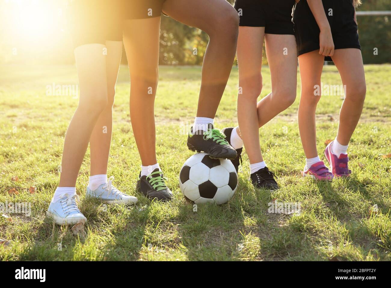 Children with ball on football field, closeup Stock Photo - Alamy