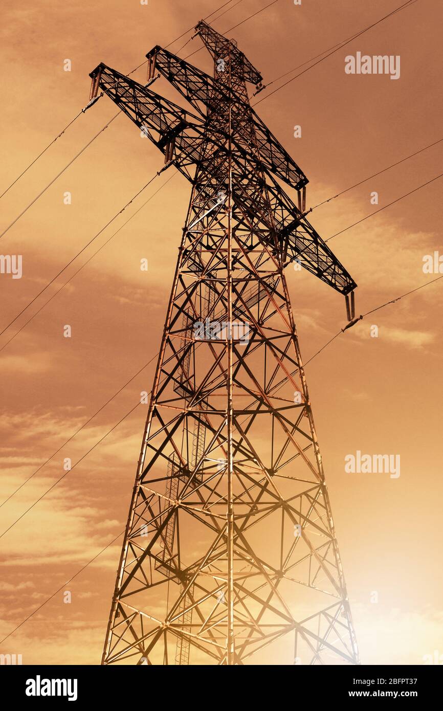 Electrical transmission tower on sky background at sunset Stock Photo ...