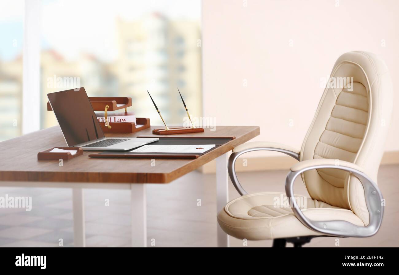 Workplace of lawyer in modern office with cityscape view through window ...