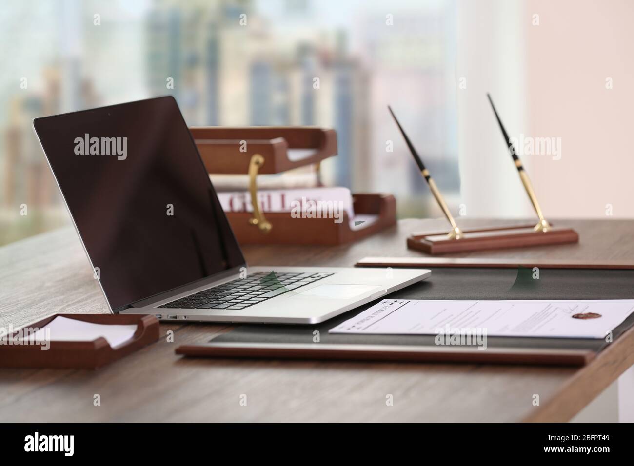 Workplace of lawyer in modern office with cityscape view through window ...