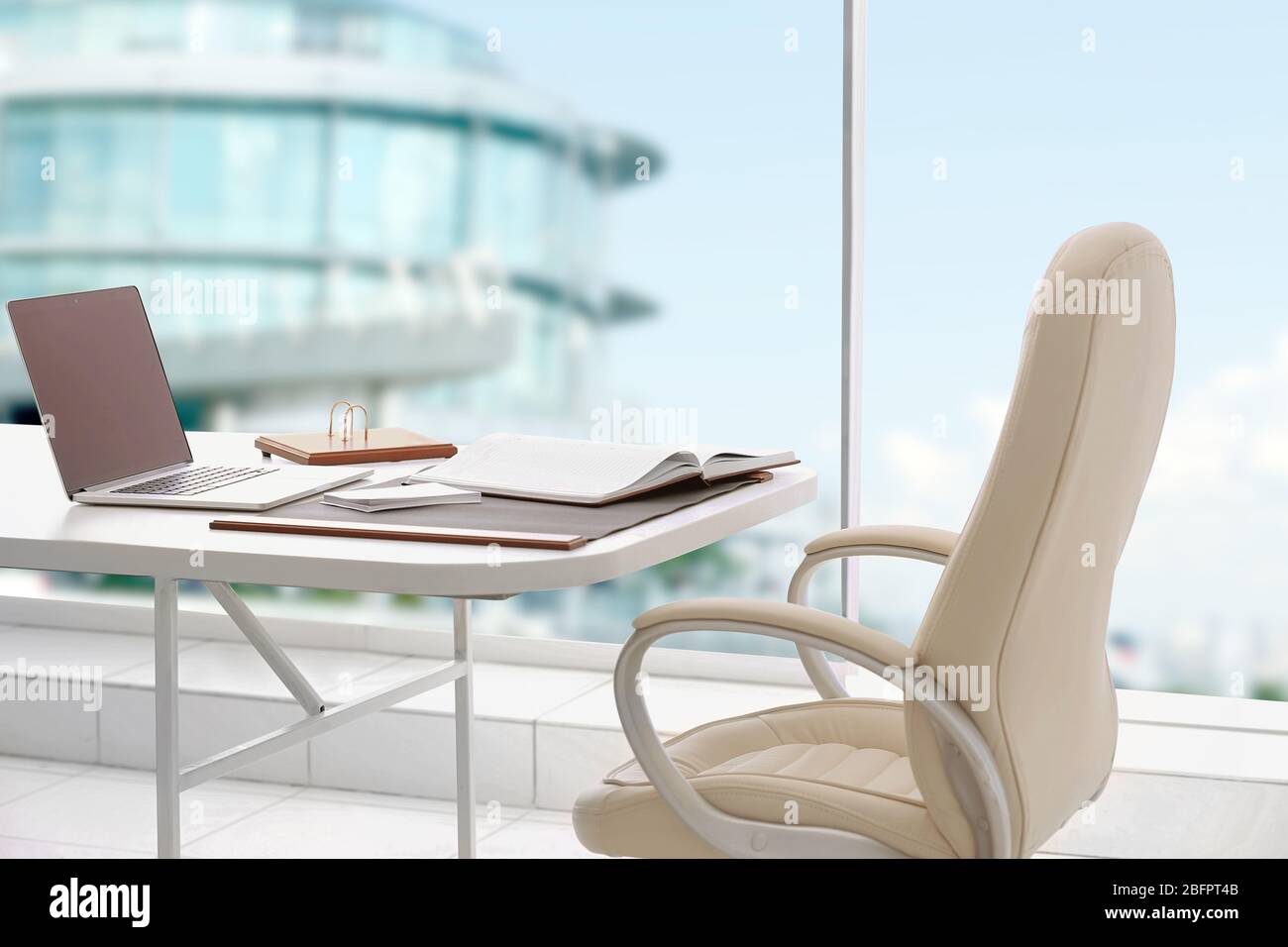 Workplace of lawyer in modern office with cityscape view through window ...