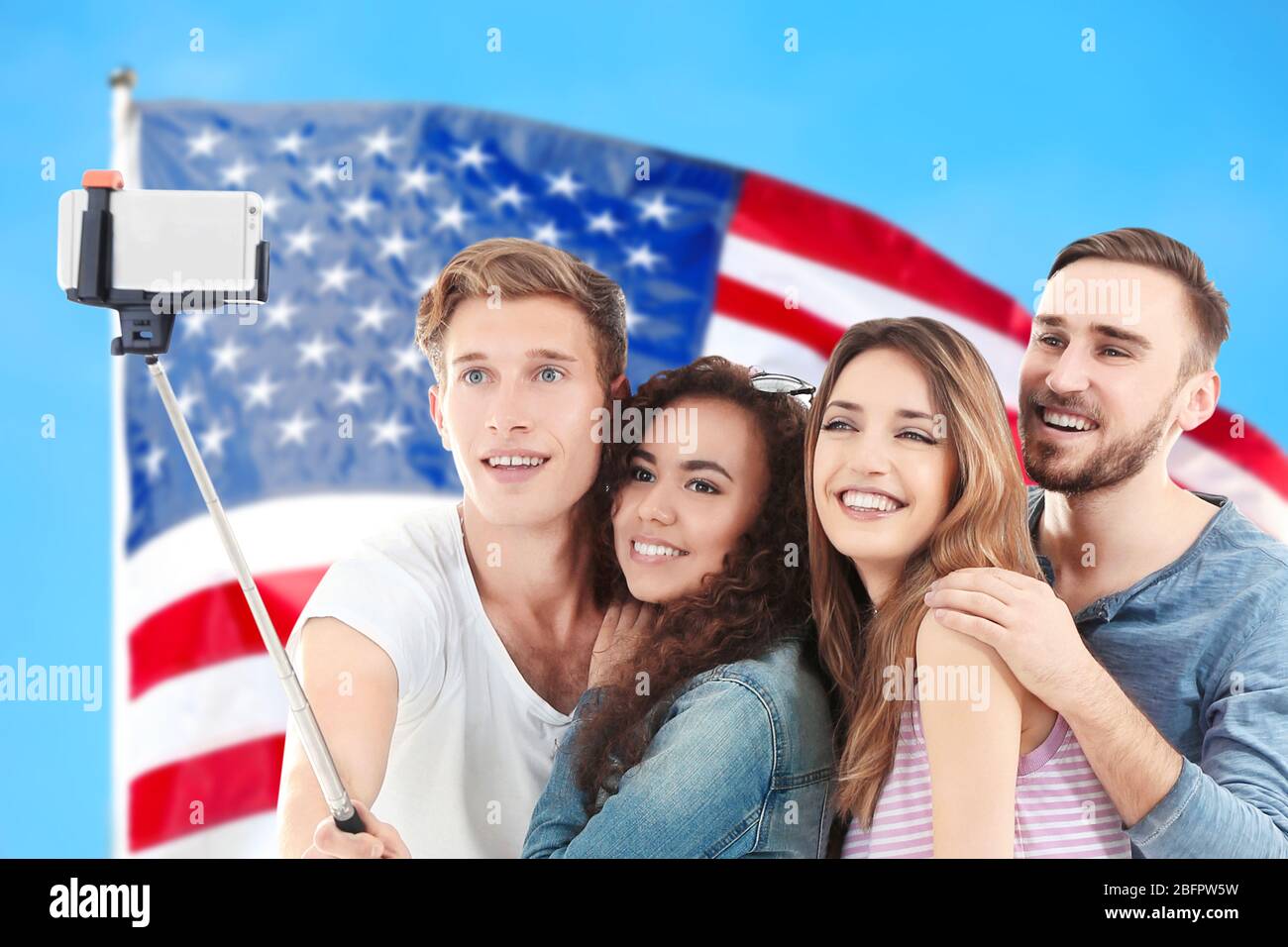 Friends tacking selfie and USA flag on background Stock Photo - Alamy