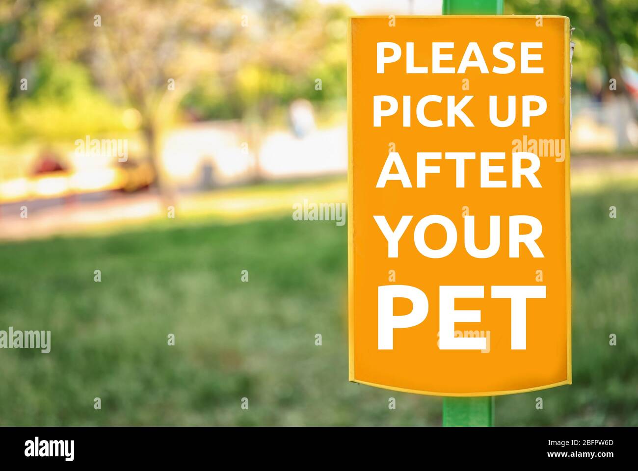 Signboard with text PLEASE PICK UP AFTER YOUR PET at park Stock Photo ...