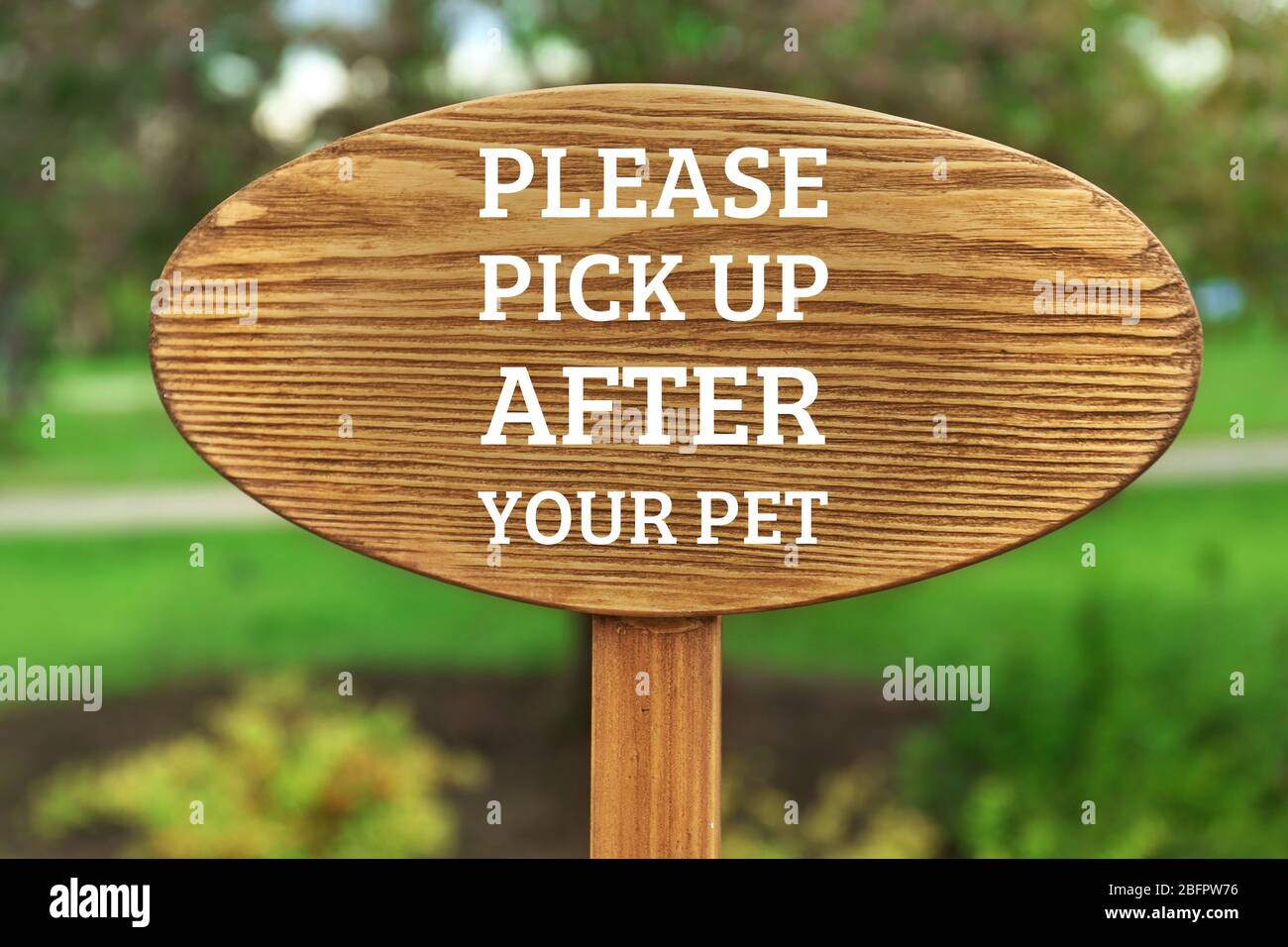 Signboard with text PLEASE PICK UP AFTER YOUR PET at park Stock Photo ...