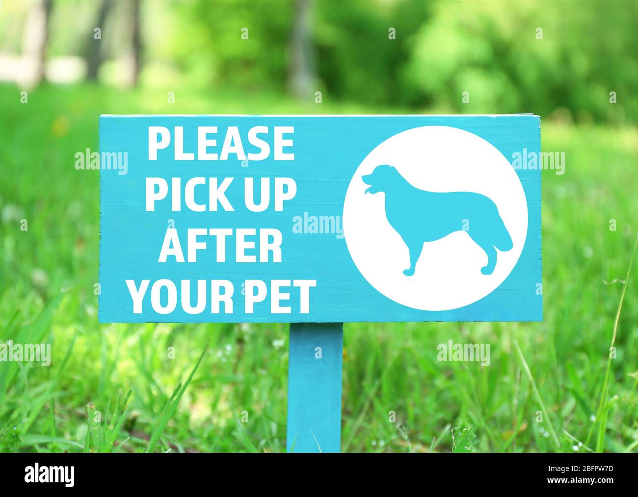 Signboard with text PLEASE PICK UP AFTER YOUR PET at park Stock Photo ...