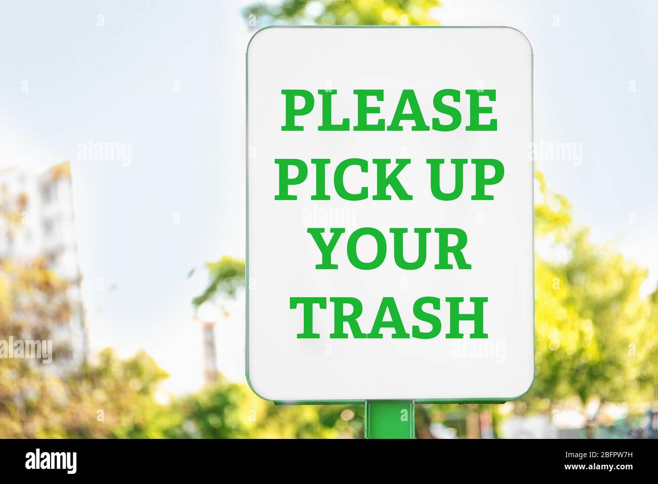 Signboard with text PLEASE PICK UP YOUR TRASH outdoors Stock Photo - Alamy