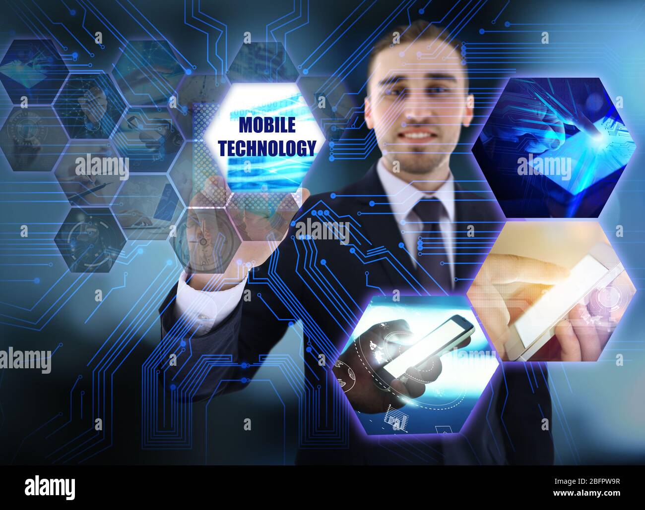 Young man pushing MODERN TECHNOLOGY button connected to gadgets on ...