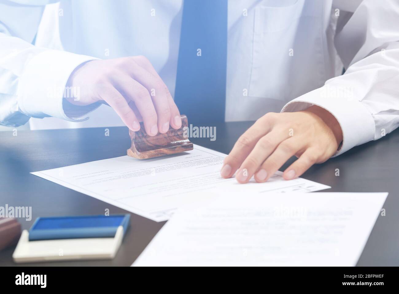 Man signing stamping documents hi-res stock photography and images - Alamy