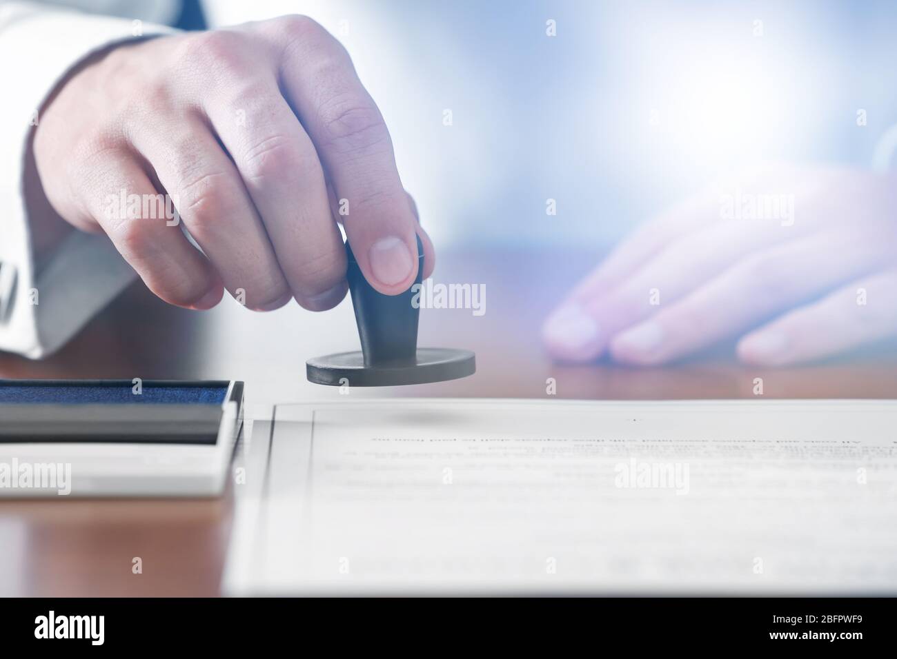 Notary public stamping document in office Stock Photo - Alamy