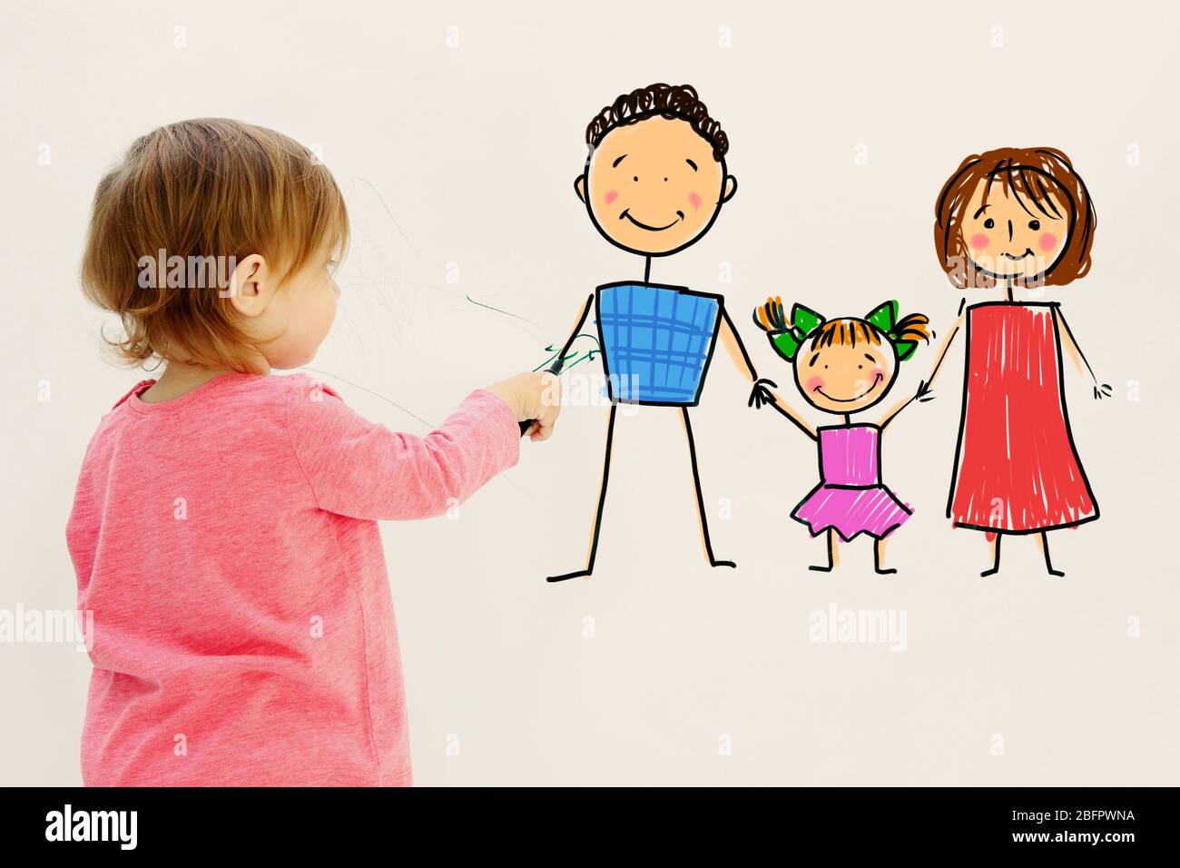 Cute little girl drawing family on light background Stock Photo - Alamy