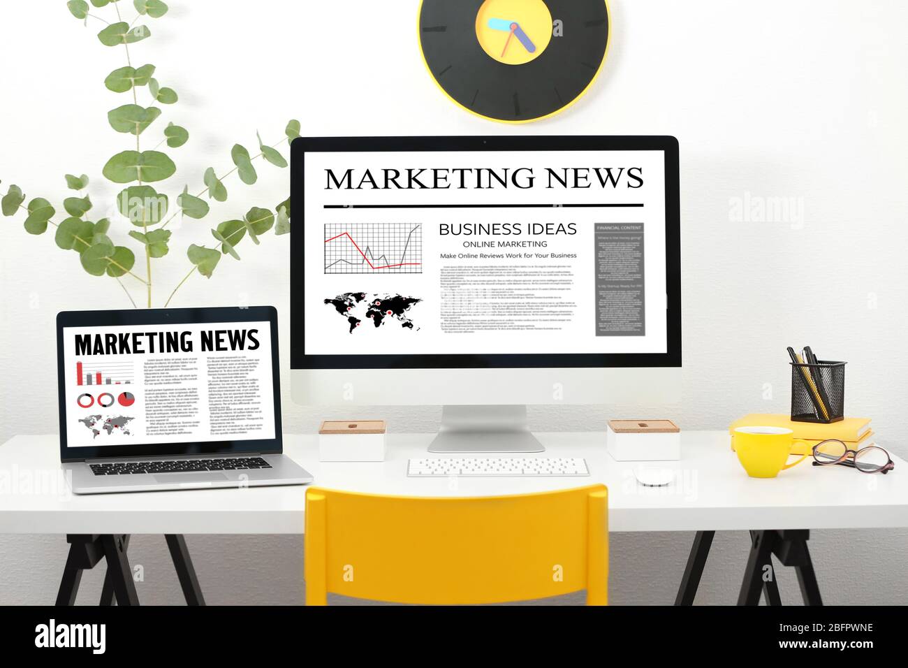 Office workplace with modern laptop and computer. Marketing news on ...