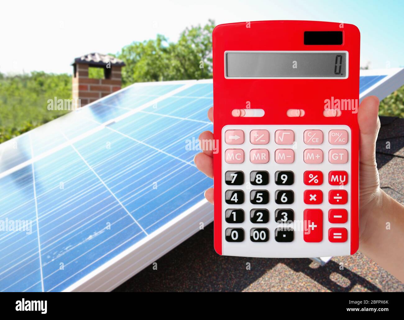Woman holding calculator and solar panels on background. Reduction of ...