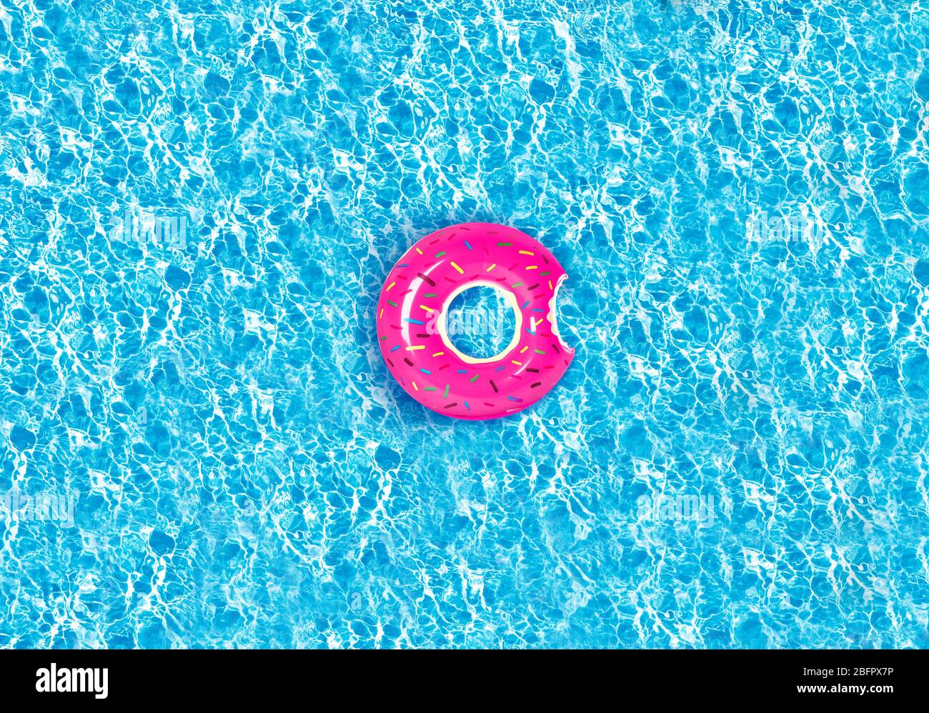 Inflatable colorful donut in swimming pool Stock Photo - Alamy