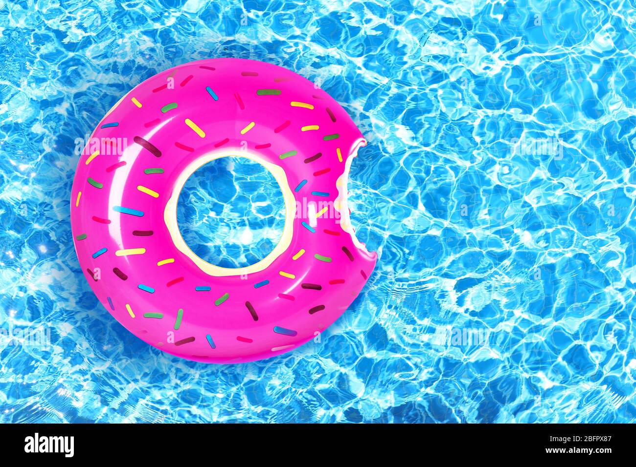 Inflatable colorful donut in swimming pool Stock Photo - Alamy