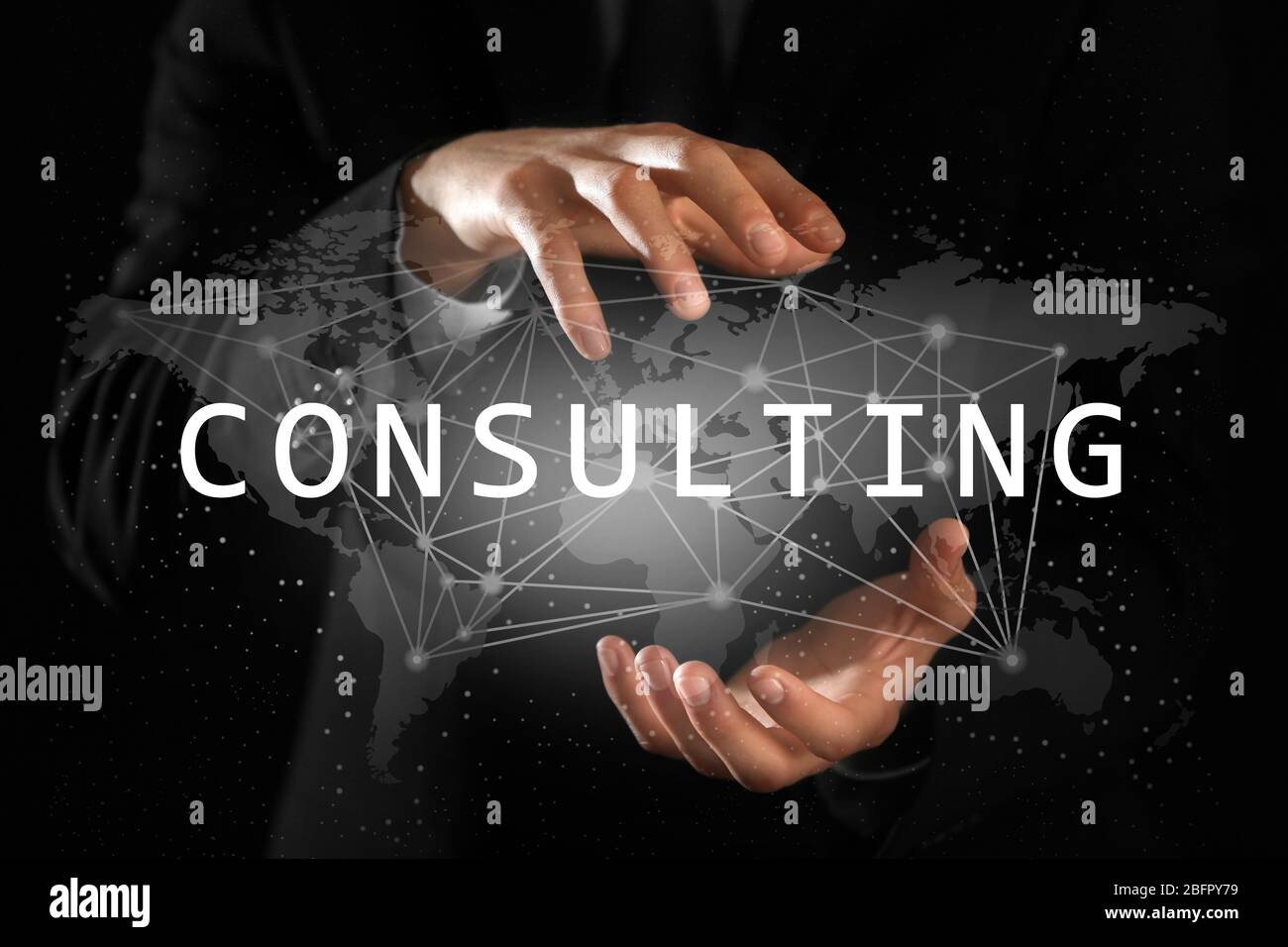 Man holding word CONSULTING on black background Stock Photo - Alamy