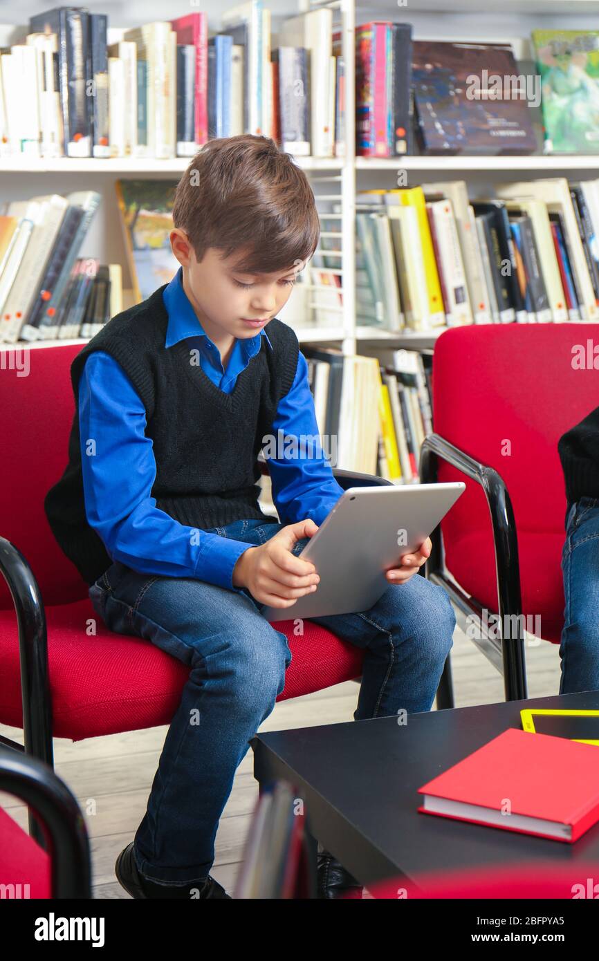 Little boy studying at school library Stock Photo - Alamy