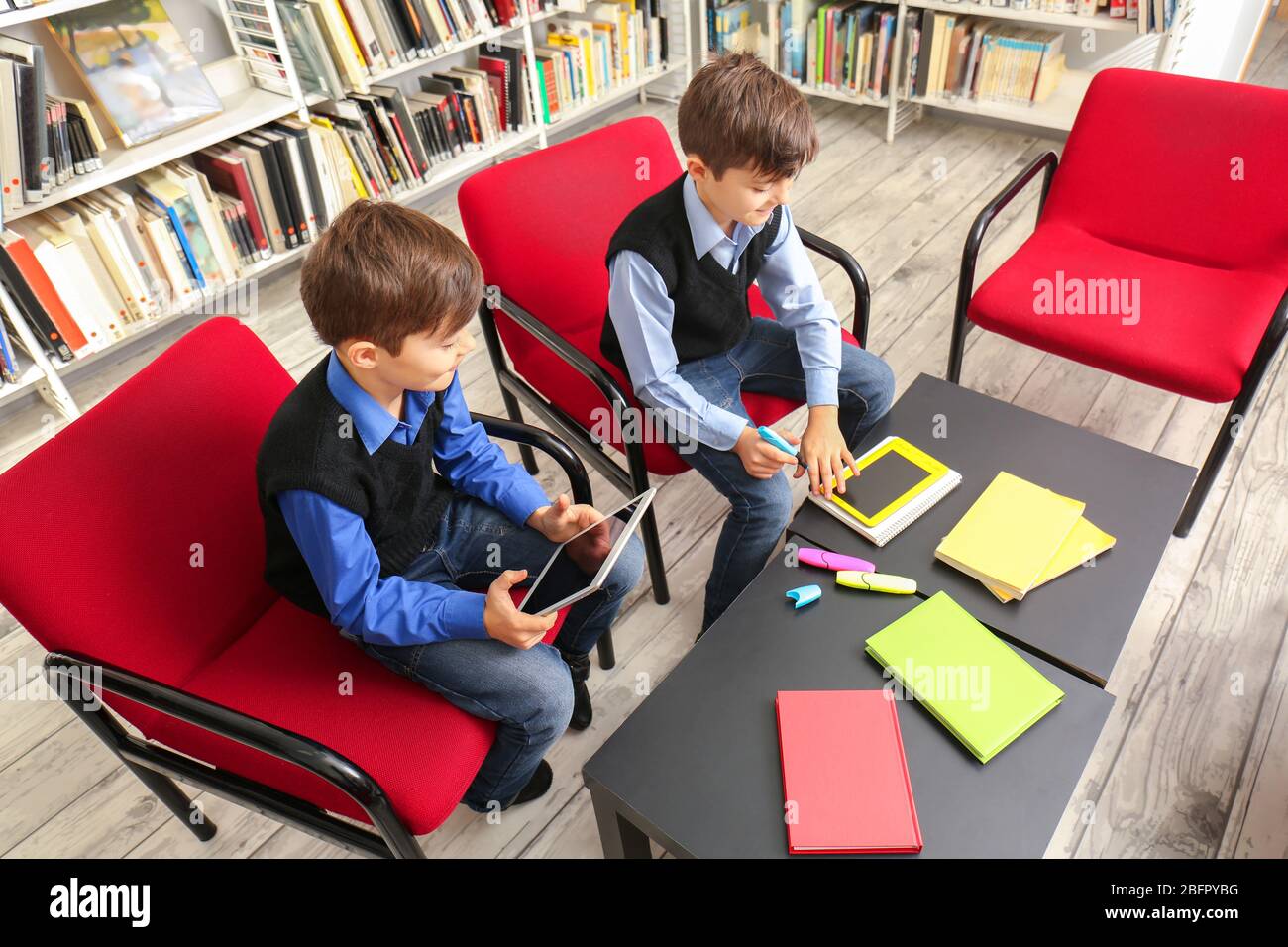 Children studying at school library Stock Photo - Alamy