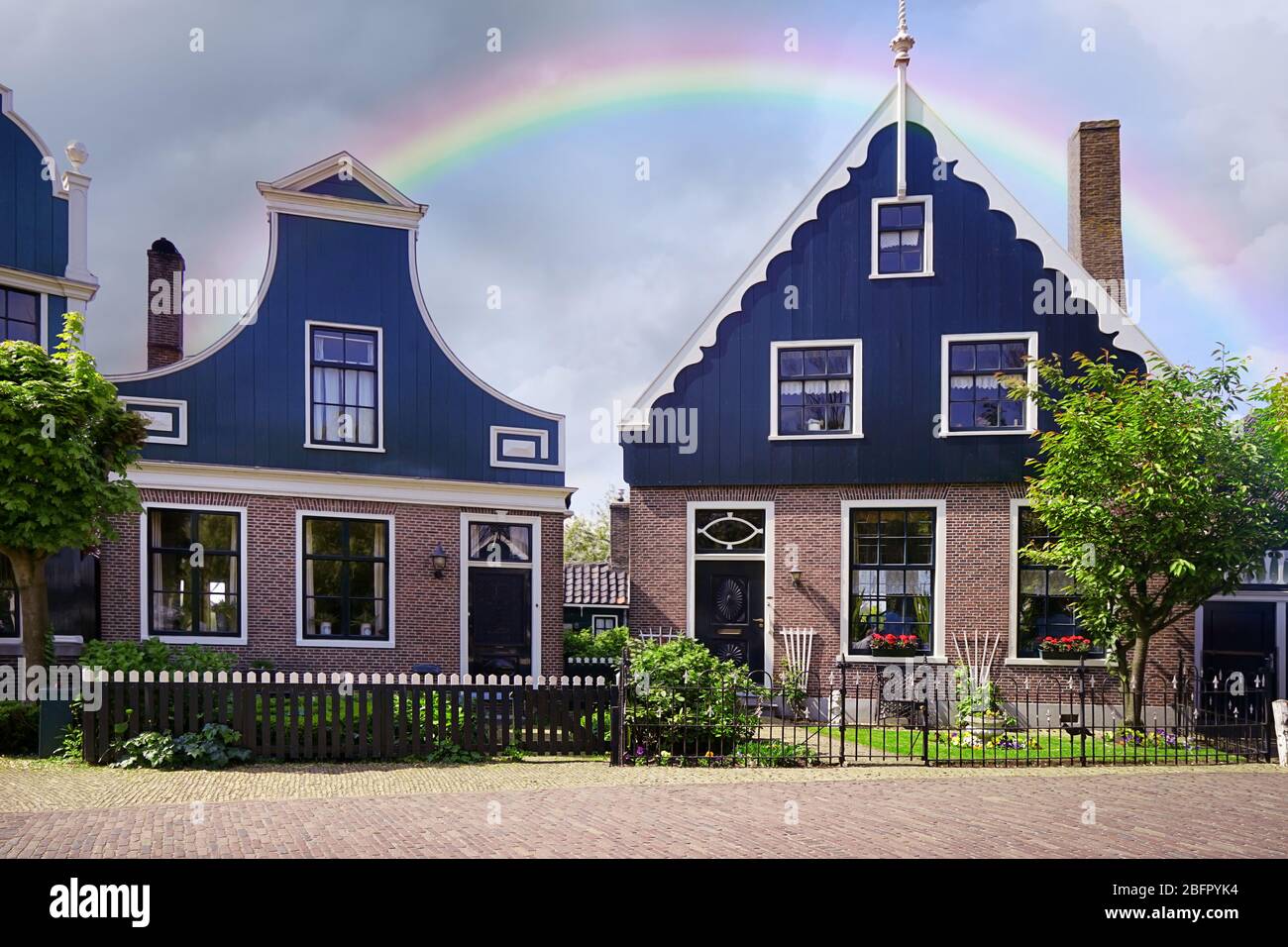 Beautiful rainbow over houses Stock Photo - Alamy