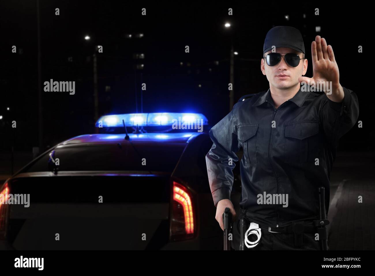 Policeman near car outdoors at night Stock Photo - Alamy