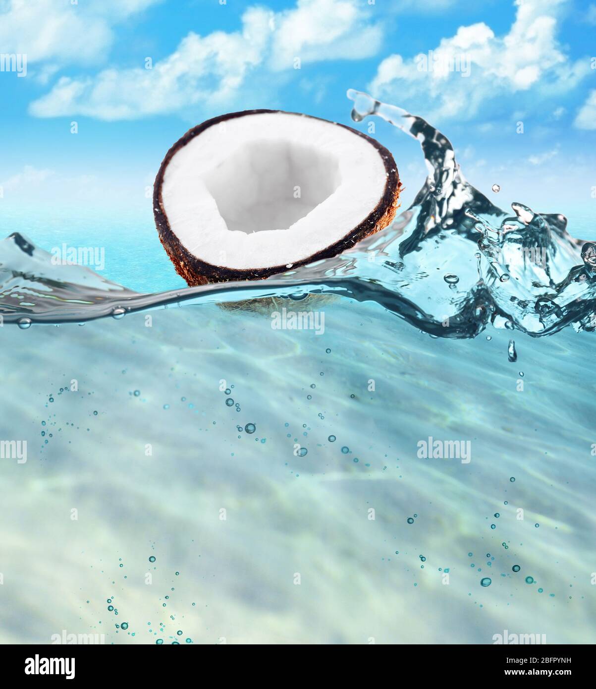 Half of coconut floating on water surface in ocean Stock Photo - Alamy