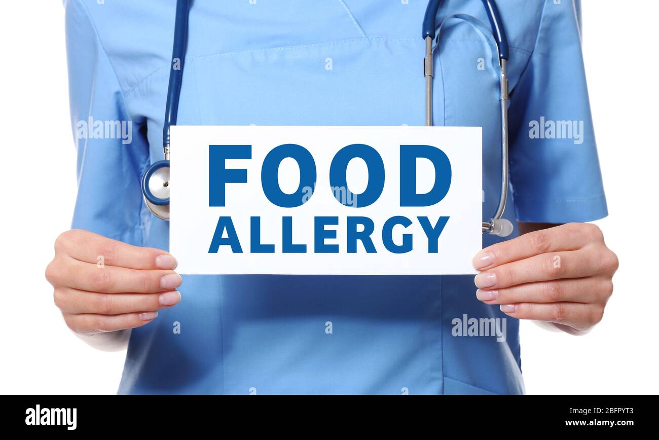 Doctor holding paper with text FOOD ALLERGY on white background Stock ...